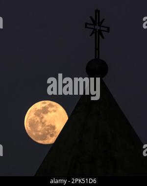 The moon rises over the cross of Armenian Orthodox Virgin Mary Church ...