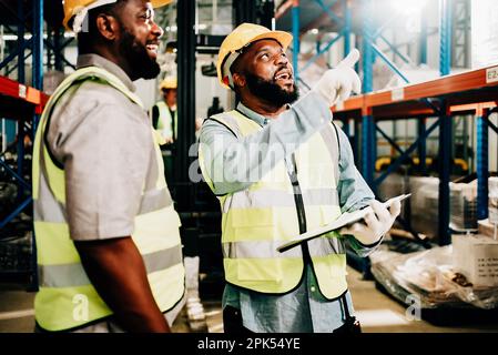 Two warehouse workers checking and controlling boxes in warehouse Stock ...