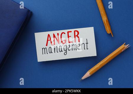 Card with words Anger Management, notebook and broken pencil on blue ...