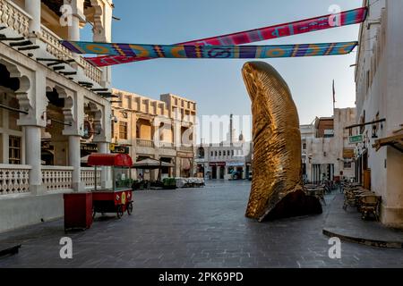 The Golden Thumb Statue, Souq Waqif, Doha, Qatar, with the Fanar Qatar ...