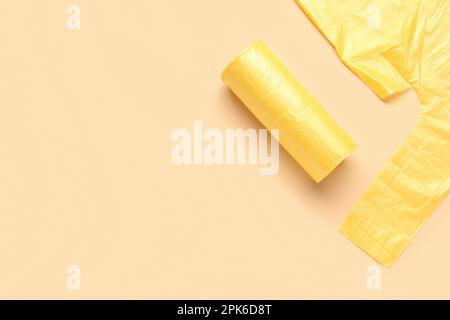 Rolled and unfolded garbage bags on beige background Stock Photo - Alamy