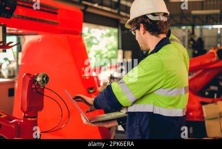 Portrait of happy male mechanical engineer in white hard hat and safety ...
