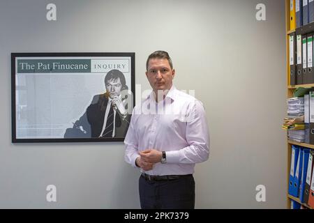 John Finucane , Irish lawyer and Sinn Féin politician with a photo of ...