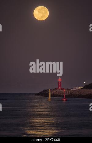 Full moon setting behind the North Mole lighthouse at Fremantle Port ...