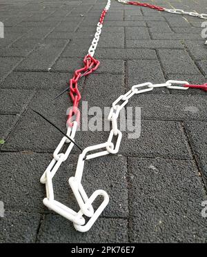 Red plastic chain on a white background Stock Photo - Alamy