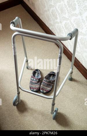 Looking down through a zimmer frame at a pair of mens slippers Stock ...