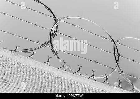 A barbed wire fence and draped frabric Stock Photo - Alamy