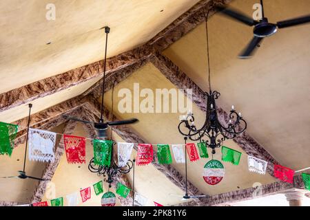 Roof of a Mexican open terrace with flags and typical decoration of ...