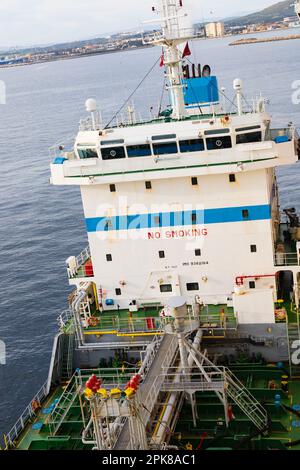 Open deck of ship refuelling tanker bulker service boat at work. Pipes ...