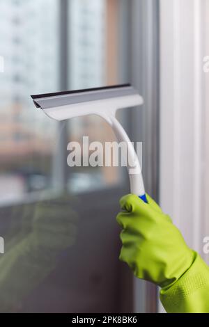 Hand in Green Glove Wiping Window with Microfiber Rag. Professional ...