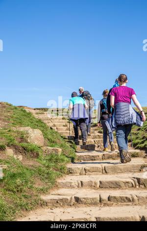 People climbing to the summit of Mam Tor Iron Age hill fort in the Peak ...