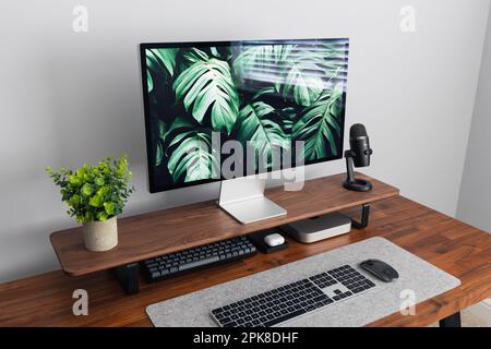 LONDON - APRIL 06, 2023: Minimal desk setup in modern home office with ...