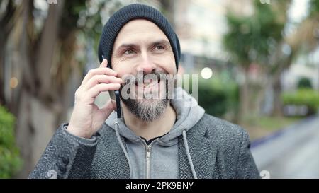 Young bald man smiling confident talking on the smartphone at street ...