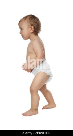 Cute baby in diaper learning to walk on white background Stock Photo ...