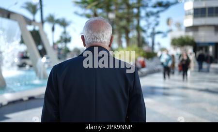 senior standing backwards at street Stock Photo - Alamy
