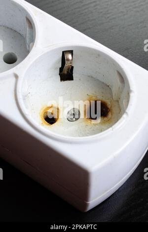 Old burnt extension cord on a white background Stock Photo - Alamy