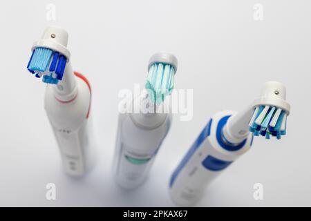 Three different electric toothbrushes, Braun Oral-B, Philips Sonicare ...