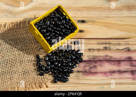 yellow box with brazilian black beans on rustic wooden board Stock ...