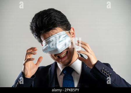 Screaming man wearing a mask over his eyes Stock Photo - Alamy