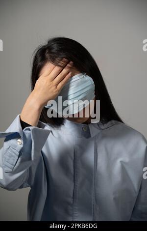 Young woman wearing a mask over her eyes Stock Photo - Alamy