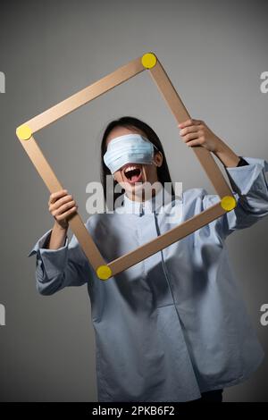 Masked and angry asian young woman Stock Photo - Alamy