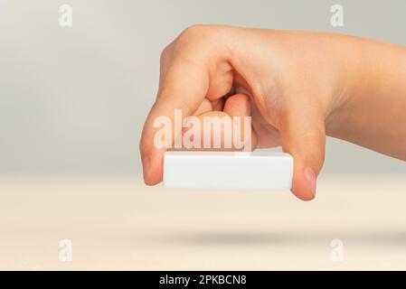 White minus symbol in hand. White mathematical symbol minus in hand on ...