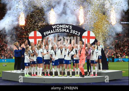 England players on the podium lift the trophy following the Women's ...