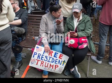 A demonstrator holds a sign during rally in opposition to COVID-19 ...