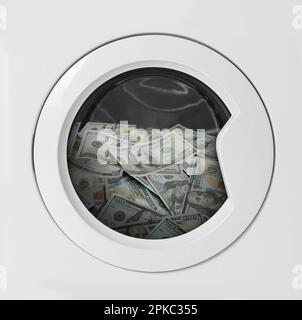 Money laundering. Many dollar banknotes in washing machine Stock Photo ...