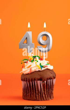 Birthday cake with candle number 49 - Rhodamine Red foamy background ...