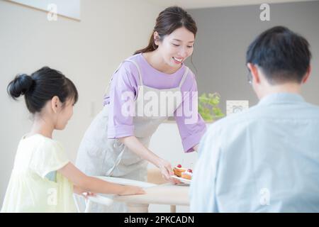 Parents and children carrying sweets to the table Stock Photo - Alamy