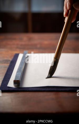 Woman's hand doing calligraphy at a desk Stock Photo - Alamy
