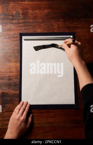 Woman's hand doing calligraphy at a desk Stock Photo - Alamy