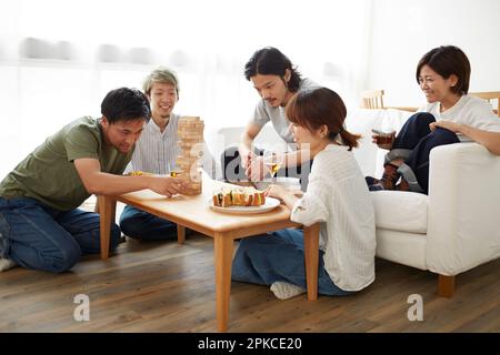 Men and women playing a balancing game Stock Photo - Alamy