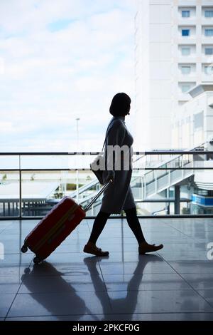 Two women walking down the aisle at the airport Stock Photo - Alamy