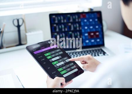 A man placing a stock order with his tablet at his desk Stock Photo - Alamy
