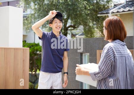 Delivery staff receiving and delivering packages Stock Photo - Alamy