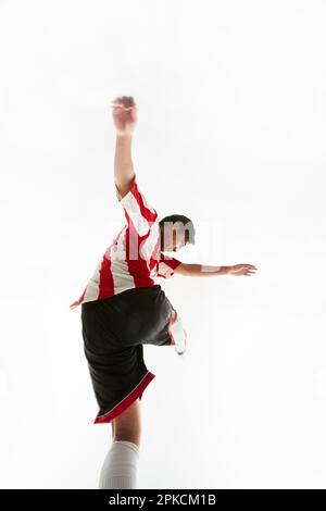 Soccer player kicking a ball and swinging his leg Stock Photo - Alamy