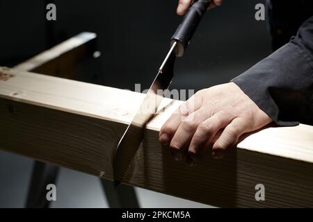 Man's hand cutting timber Stock Photo - Alamy