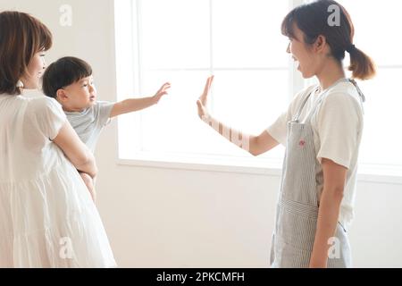 Female child care worker waving to children coming home Stock Photo - Alamy