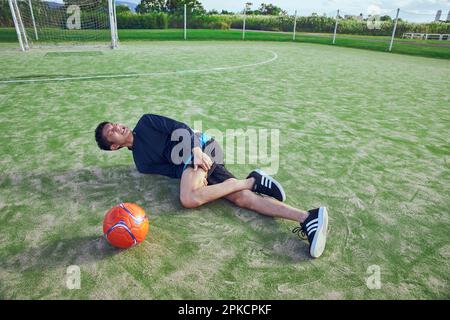 Sportsman falling down with injury Stock Photo - Alamy
