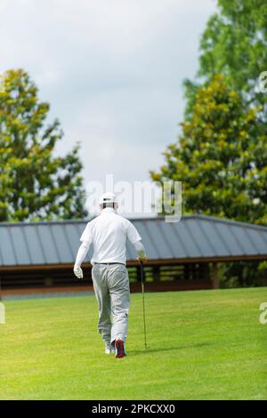 A middle-aged man playing golf Stock Photo - Alamy