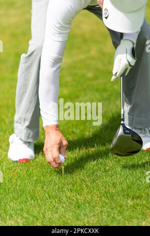 A middle-aged man playing golf Stock Photo - Alamy