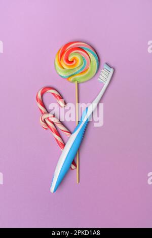 Candy canes, lollipops and toothbrush, dental hygiene Stock Photo - Alamy