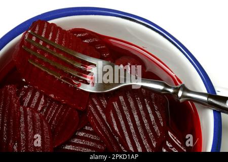 Sliced pickled beetroot with peel and fork, Beta vulgaris Stock Photo ...