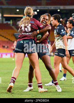 Ivania Wong (centre) of the Reds celebrates scoring a try with team ...