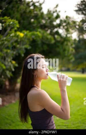 Profile of a woman drinking water from canteen in a waterfall Stock ...