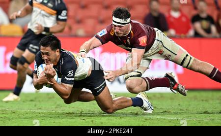 Tamati Tua (left) of the Brumbies dives over to score a try during the ...