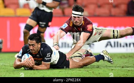 Tamati Tua (left) of the Brumbies dives over to score a try during the ...