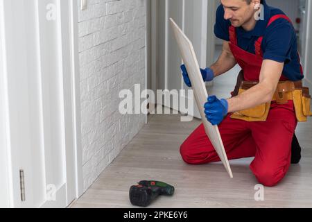 nice handyman install tile on the floor Stock Photo - Alamy